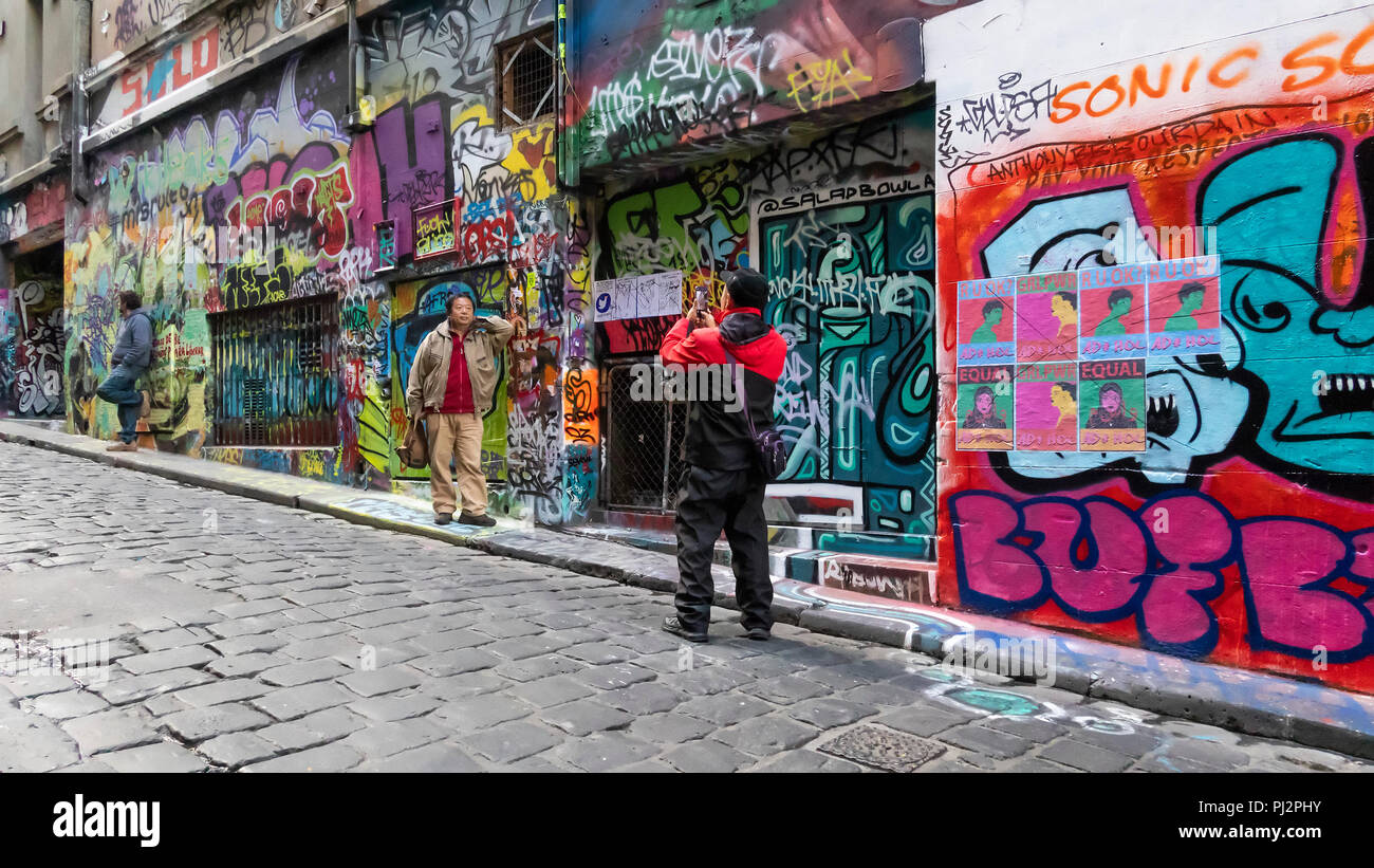 Tourists admiring street art in Hosier Lane; one of Melbourne's most ...