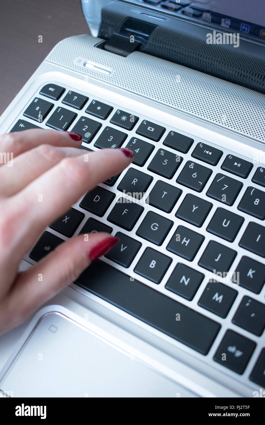 Secretary typist typing on laptop pc computer keyboard keys with hands ...