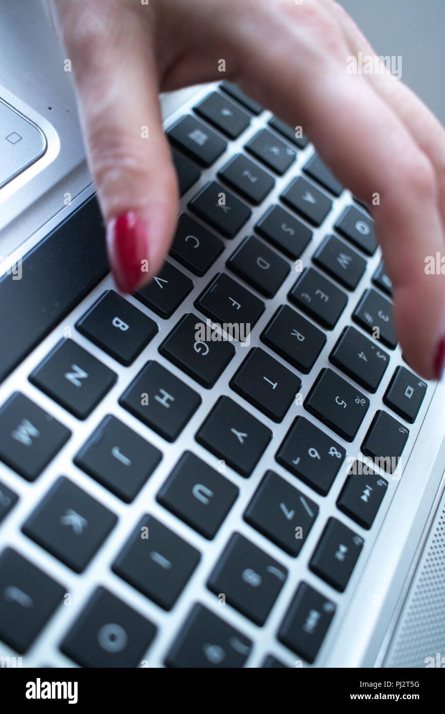 Secretary typist typing on laptop pc computer keyboard keys with hands ...