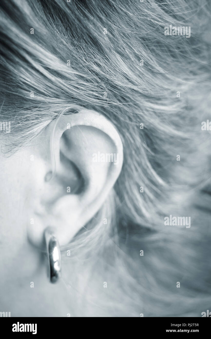 Deaf lady with modern technology digital hearing aid in her ear Stock ...