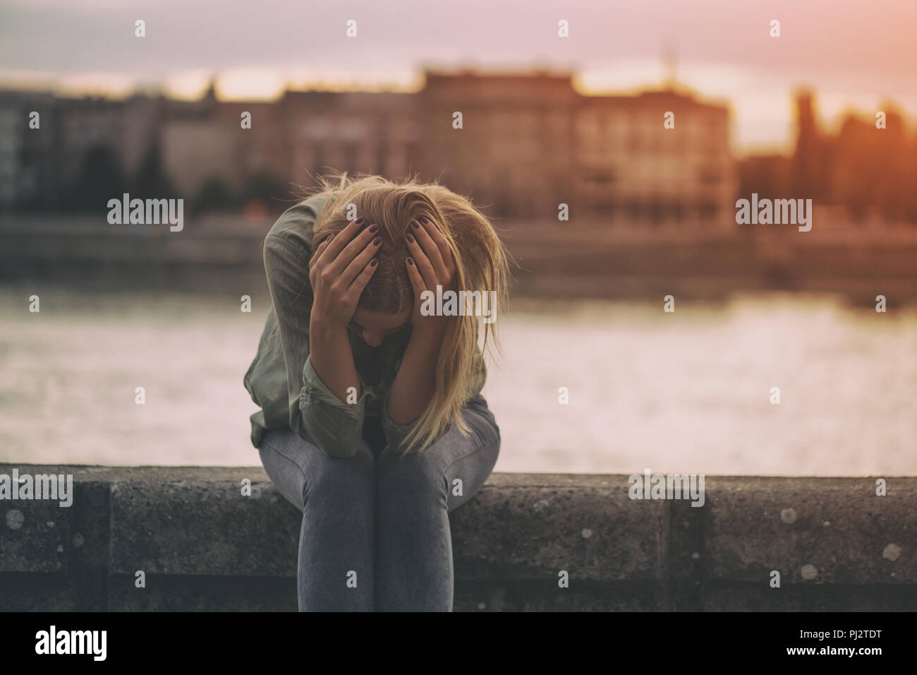 Sad pensive blonde woman sitting hi-res stock photography and images ...
