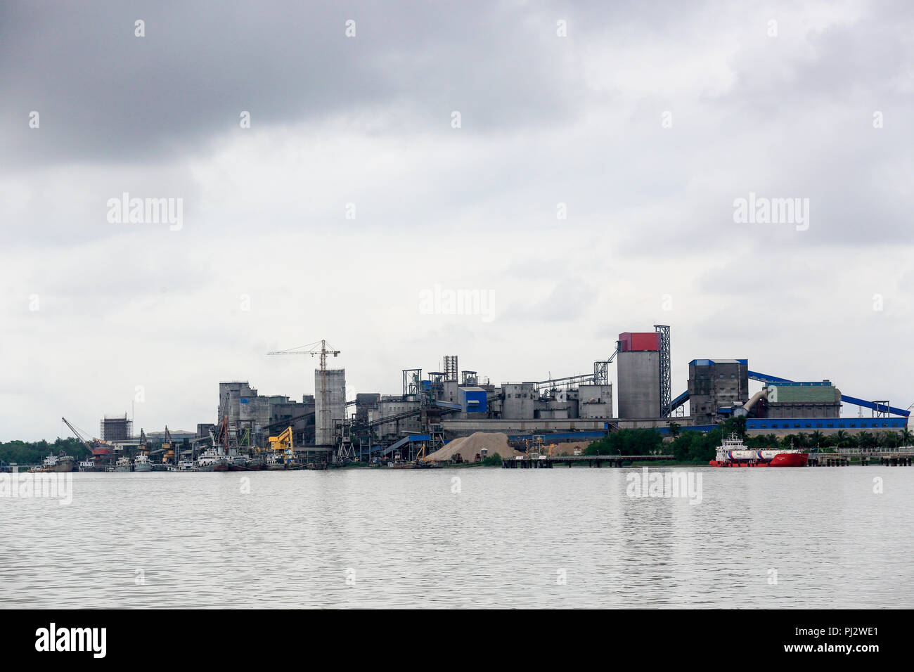 Cement factory on the bank of Pasur River. Bagerhat, Bangladesh Stock ...