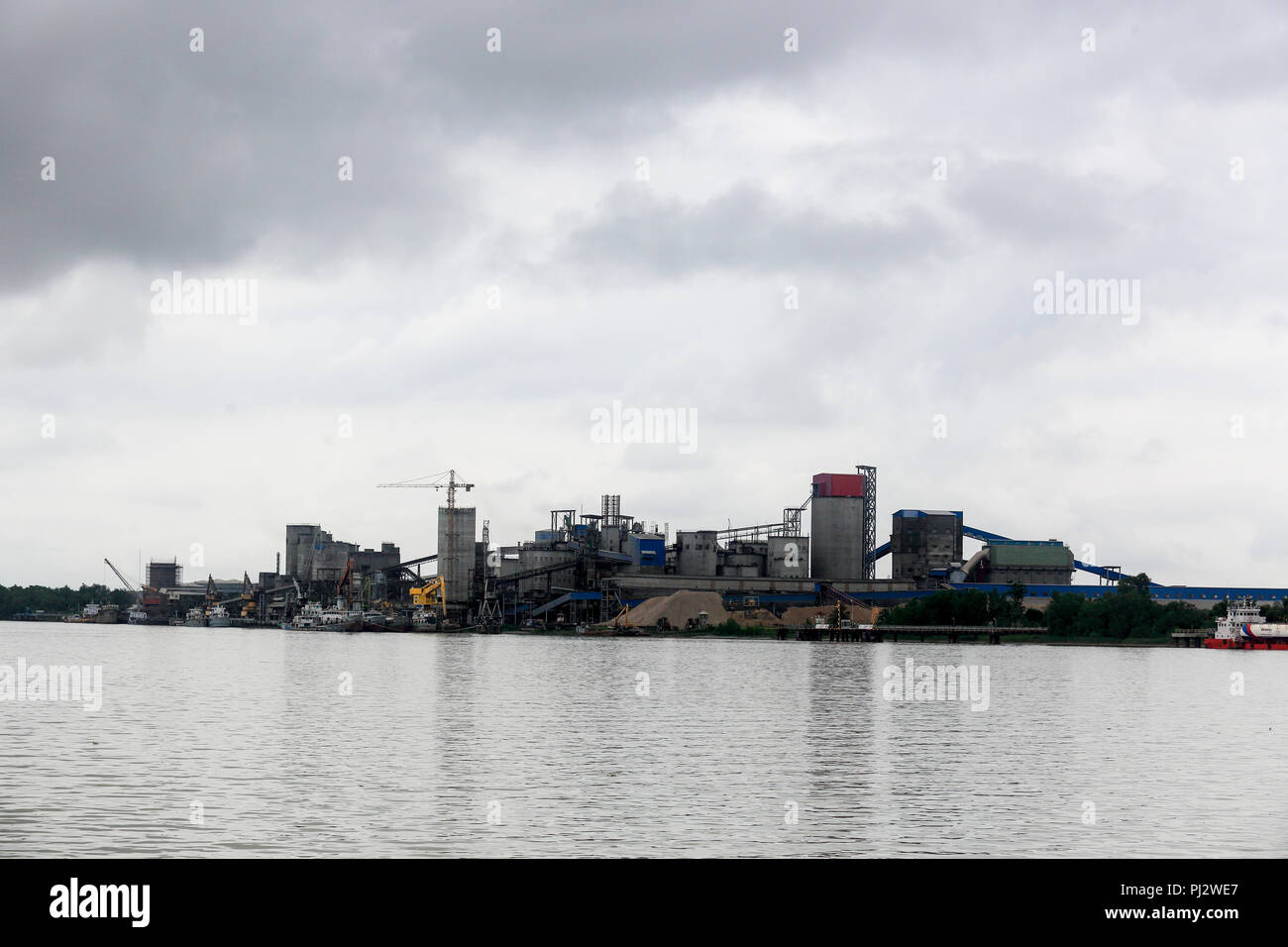 Cement factory on the bank of Pasur River. Bagerhat, Bangladesh Stock ...