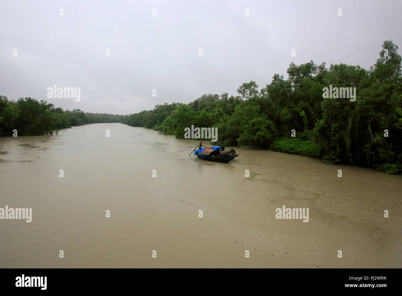Fishing boats on the Shela River in Sundarbans, a UNESCO World Heritage ...