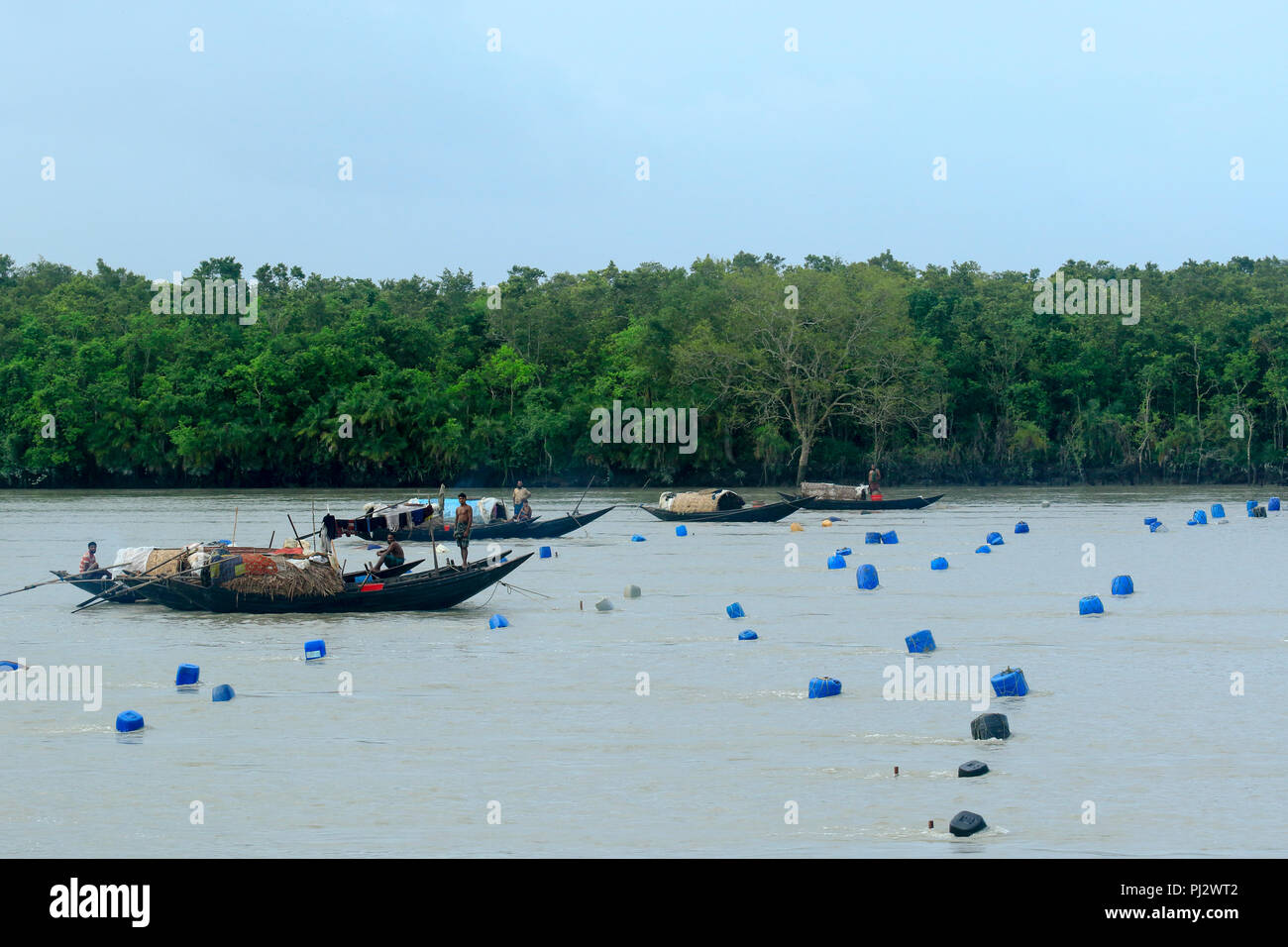 Fishing boats on the Shela River in Sundarbans, a UNESCO World Heritage ...