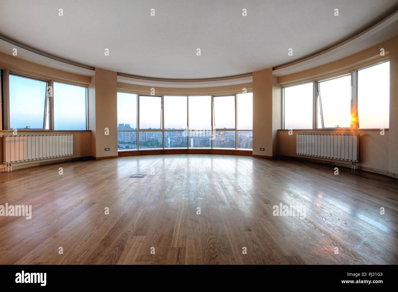 Big oval living room with glass wall Stock Photo - Alamy