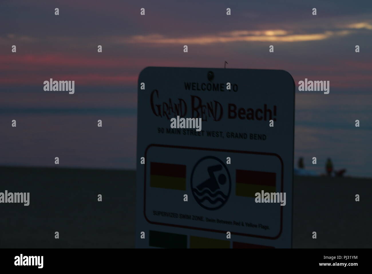 Sign for grand bend beach with a sunset in background Stock Photo - Alamy