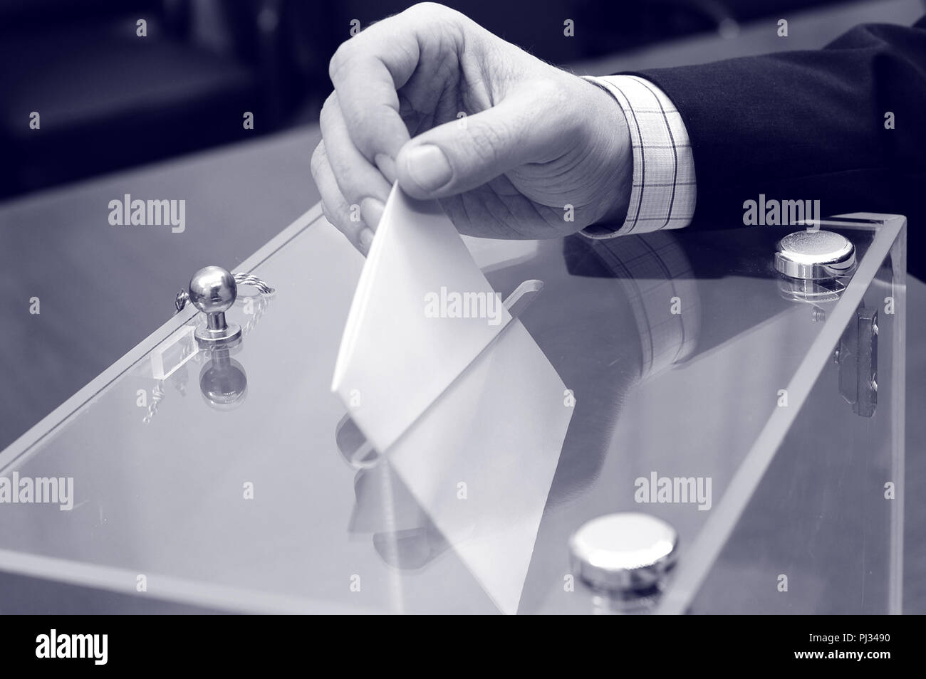 Image of a ballot box and hand putting a blank ballot inside,elections ...