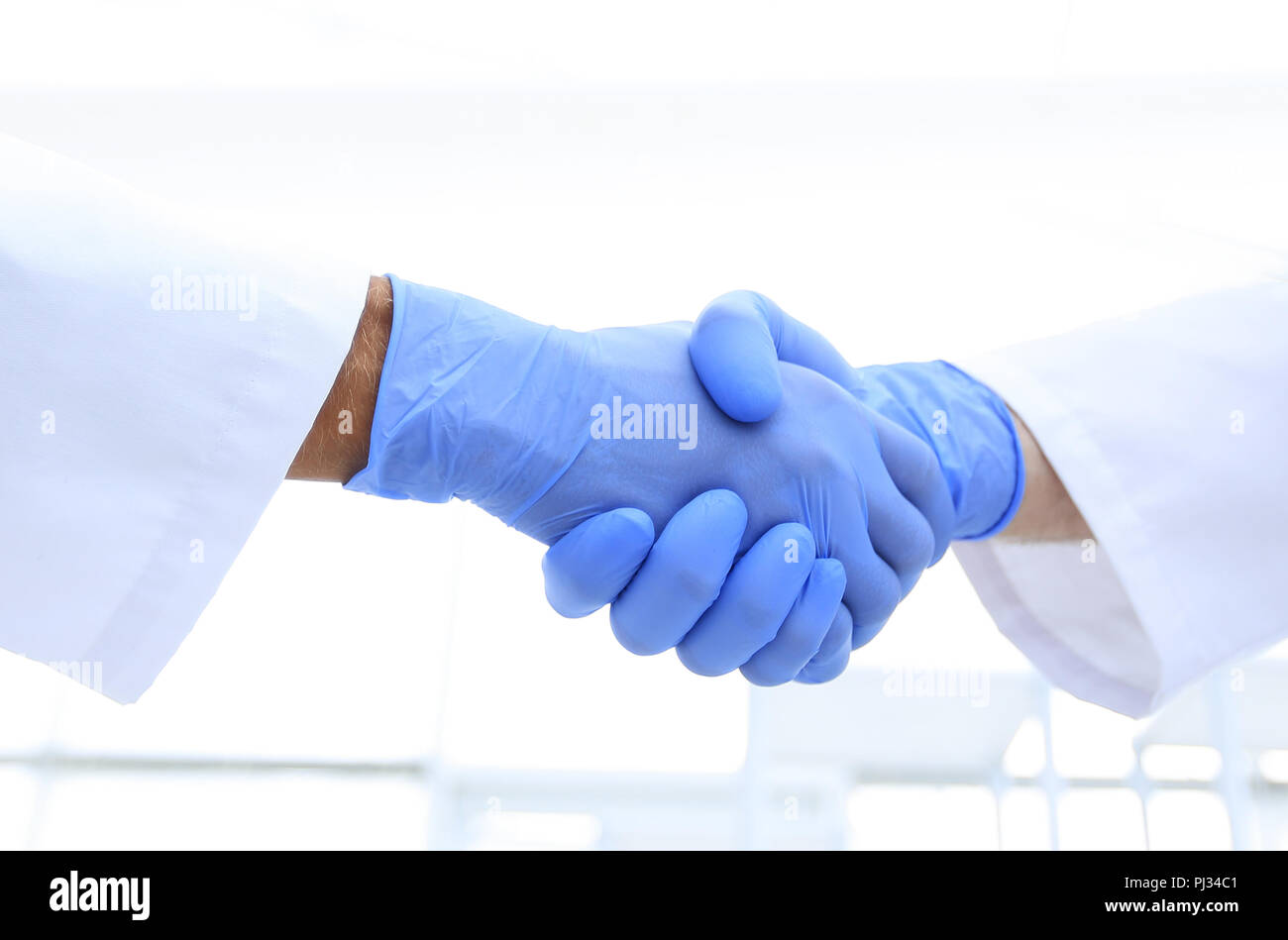 hand in the medical glove (handshake Stock Photo - Alamy