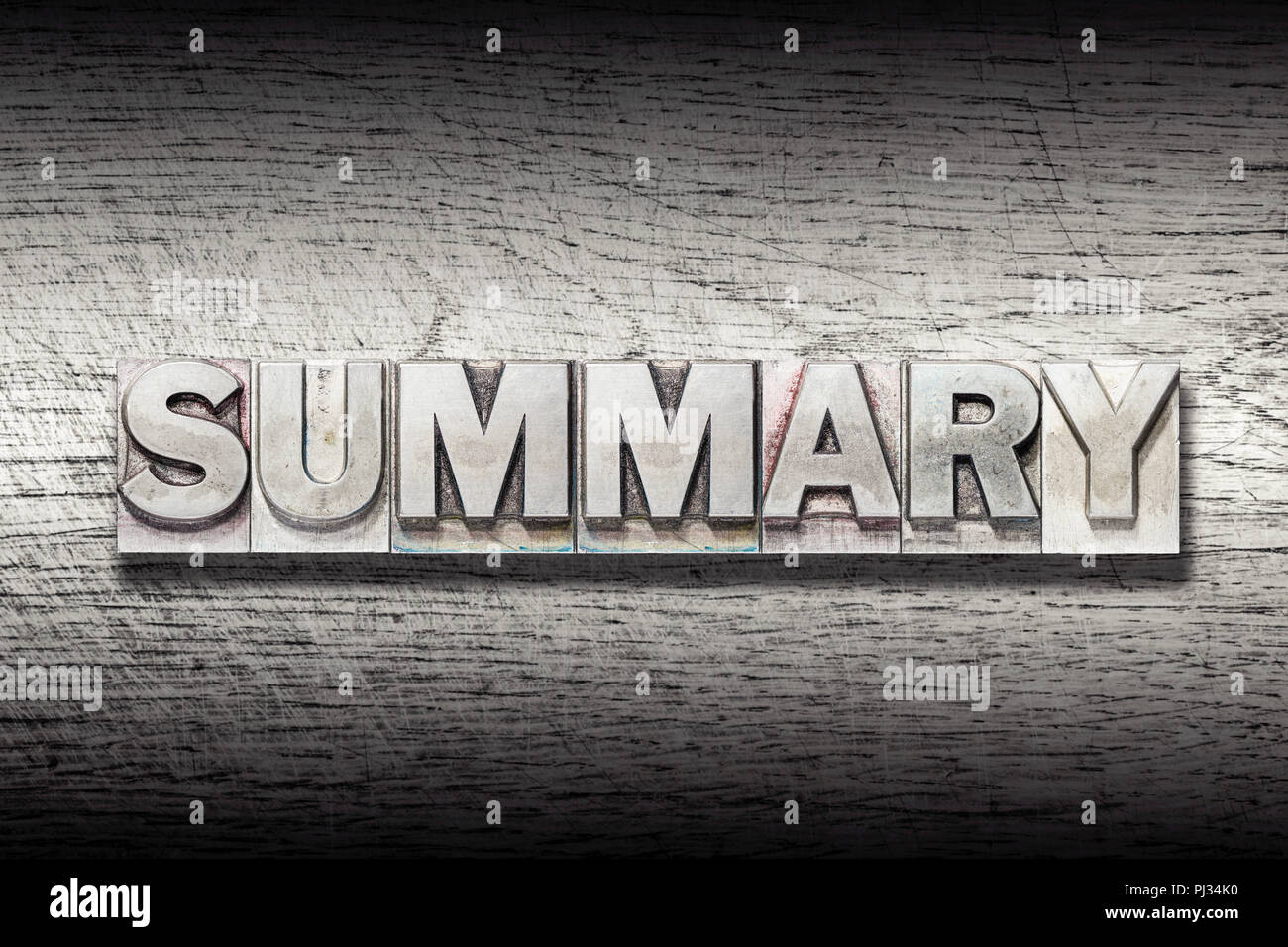 summary word made from metallic letterpress on rough wooden texture ...