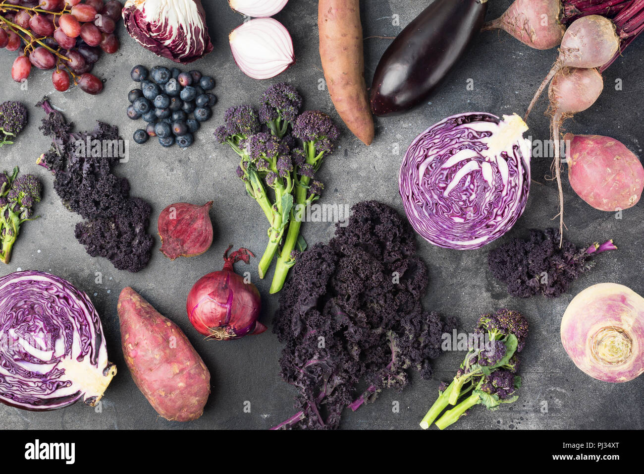 Vegetables and fruits background in purple, green and dark red colours ...