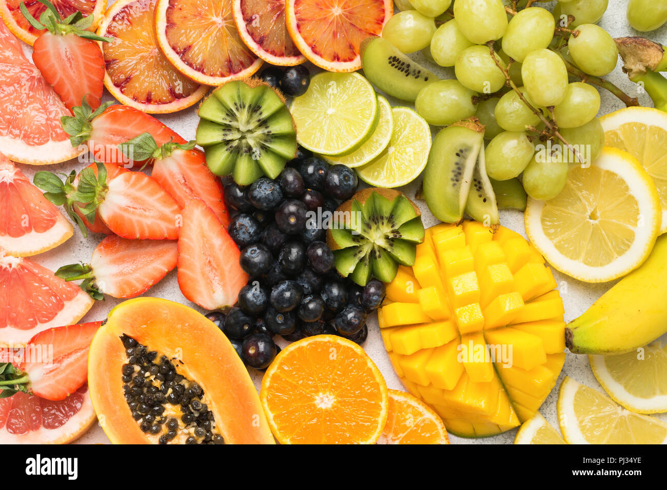 Healthy colourful fruits in rainbow colours, strawberries, mango ...