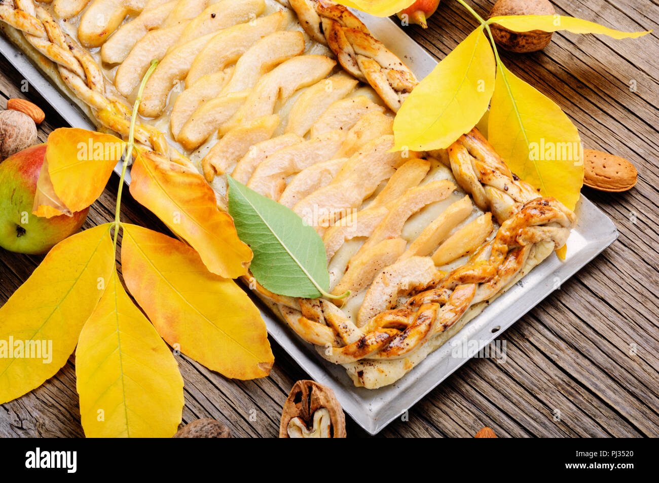 Rustic pie with pears and fallen autumn foliage. Autumn kitchen Stock ...
