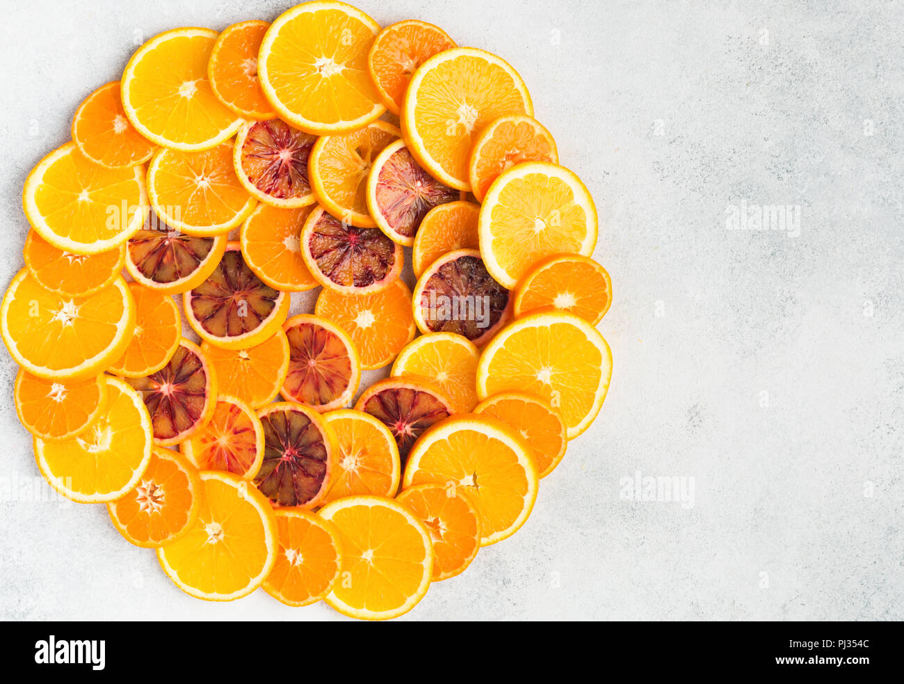 Different varieties of citrus fruits arranged in a circle background on ...