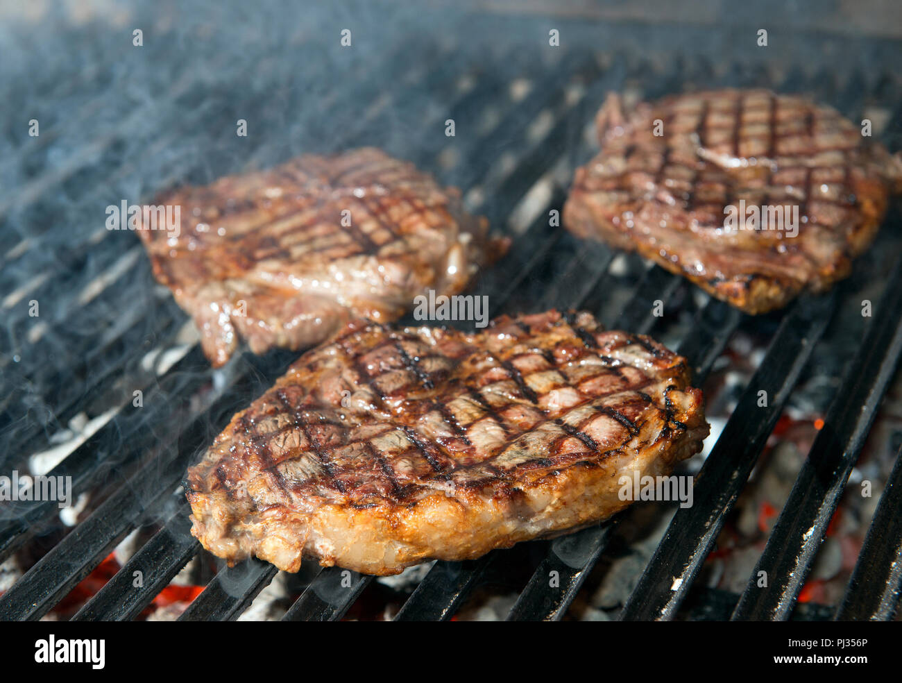 beef steak cooking on an open flame grill Stock Photo - Alamy