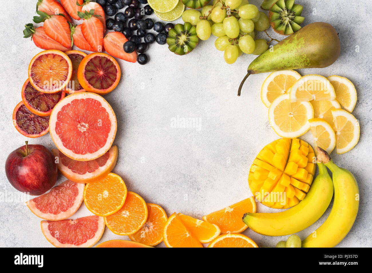 Healthy eating, top view of healthy fruits in rainbow colours in a ...