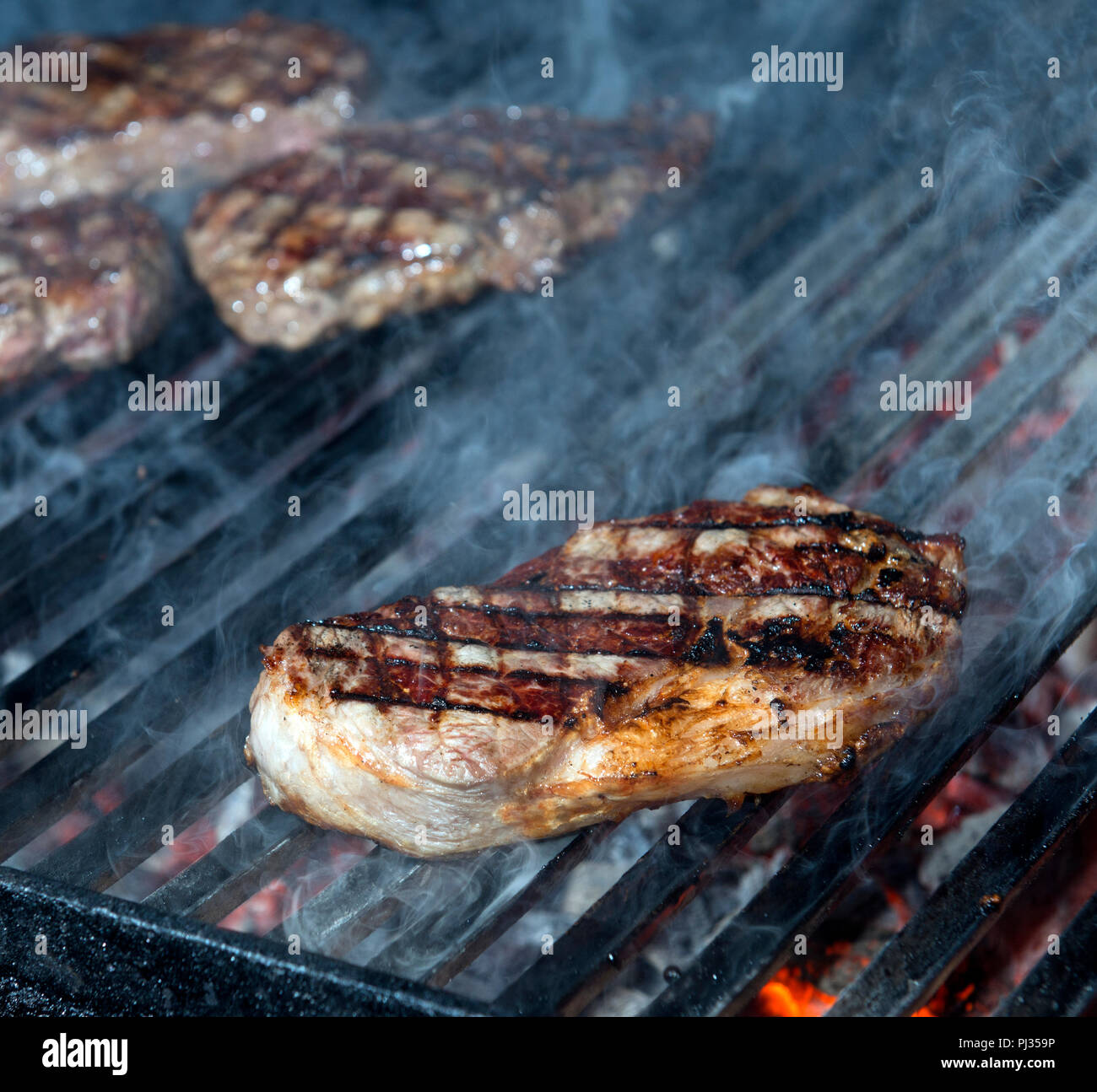 beef steak cooking on an open flame grill Stock Photo - Alamy