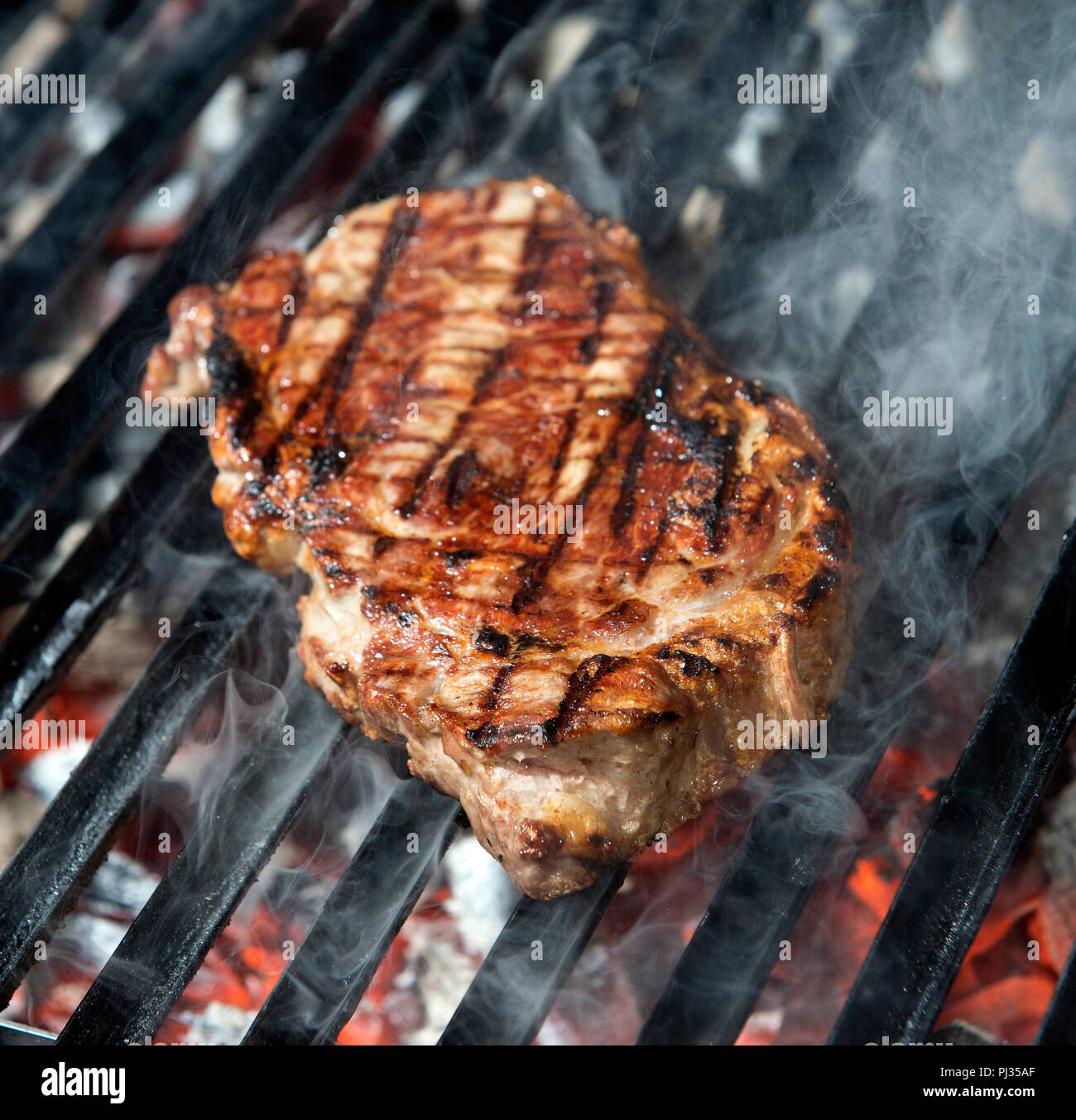 beef steak cooking on an open flame grill Stock Photo - Alamy