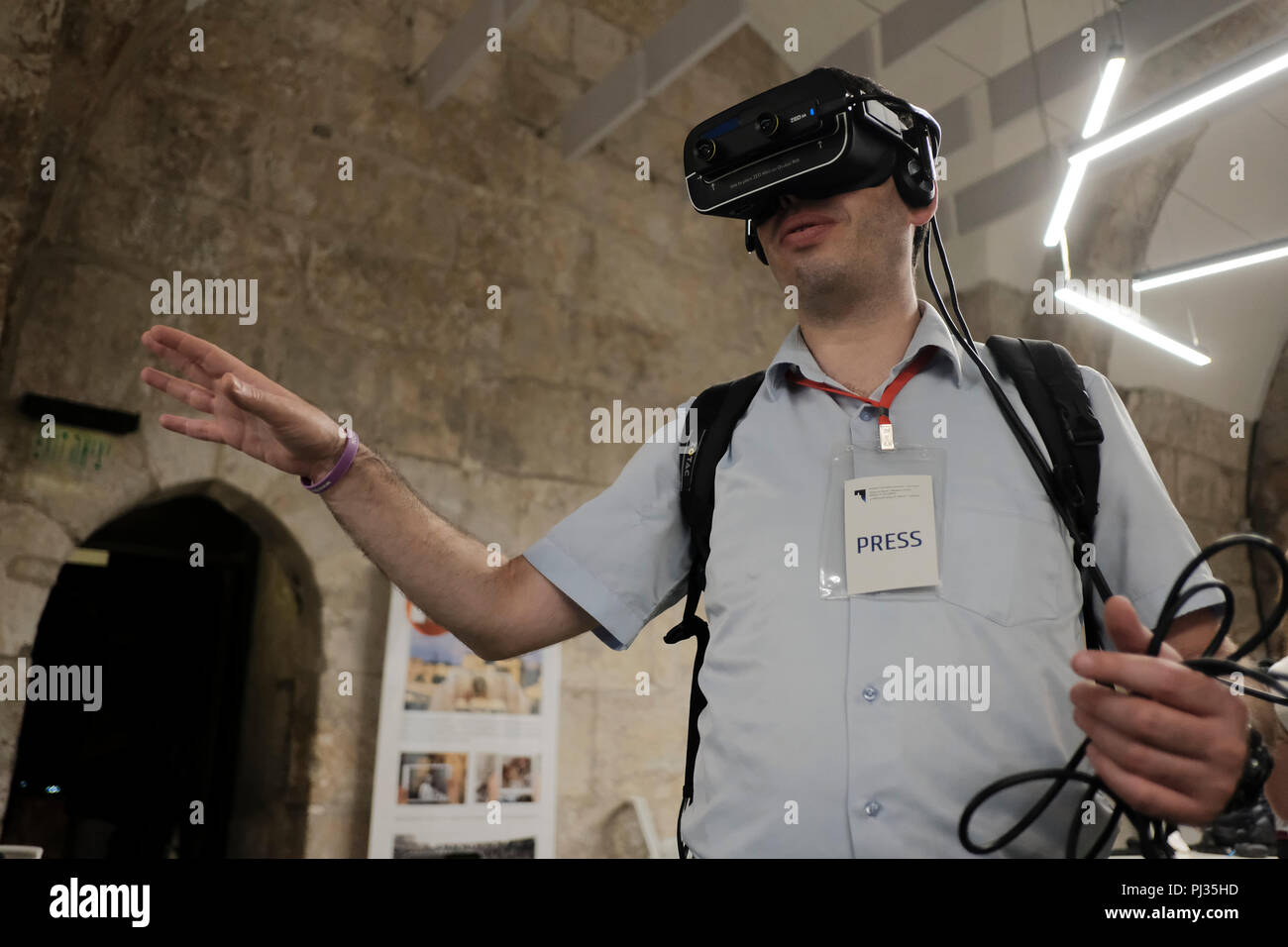 A visitor enjoys a 3D walking tour content through virtual reality VR ...