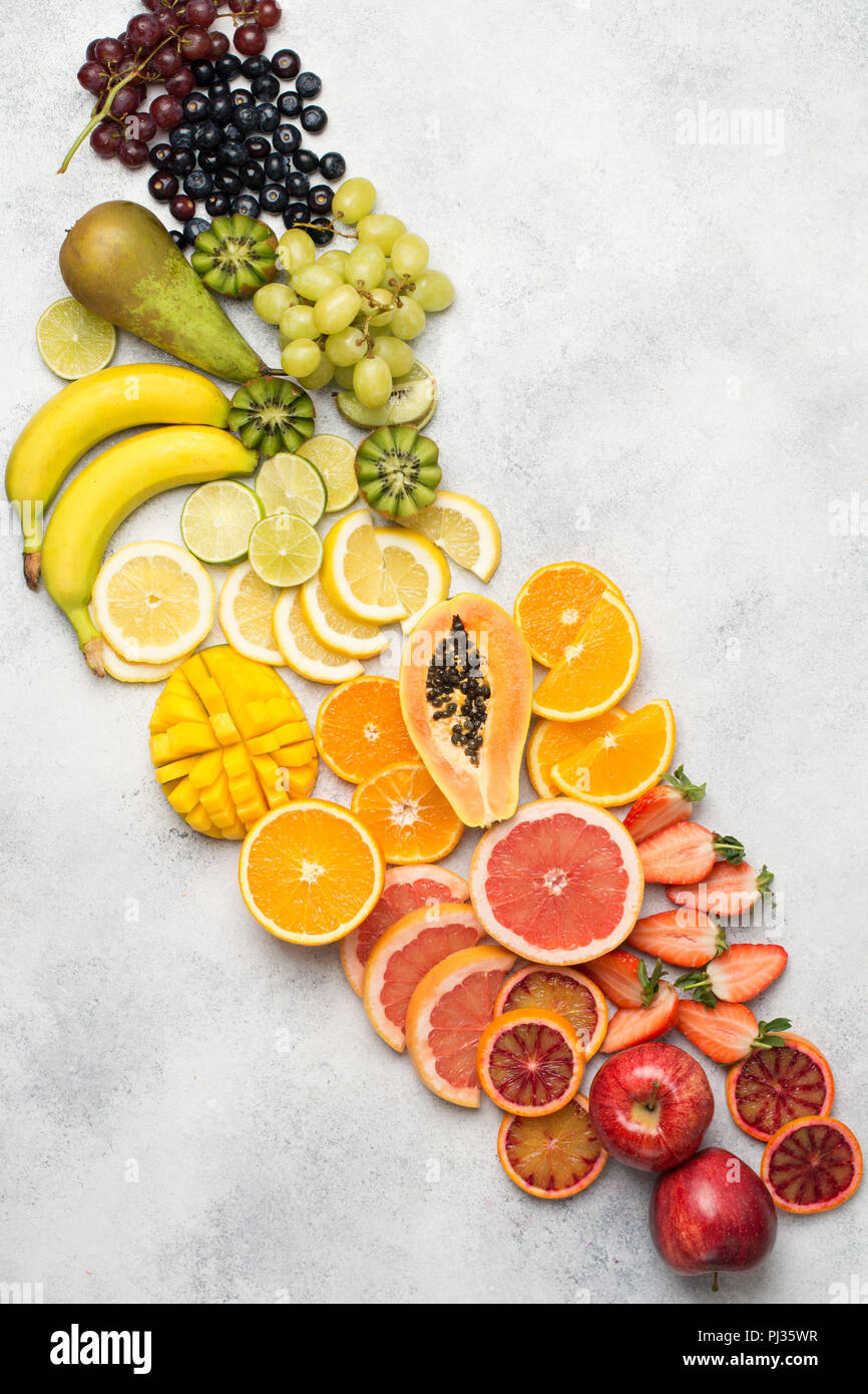 Top view of colourful fruits in rainbow colours, strawberries, mango ...