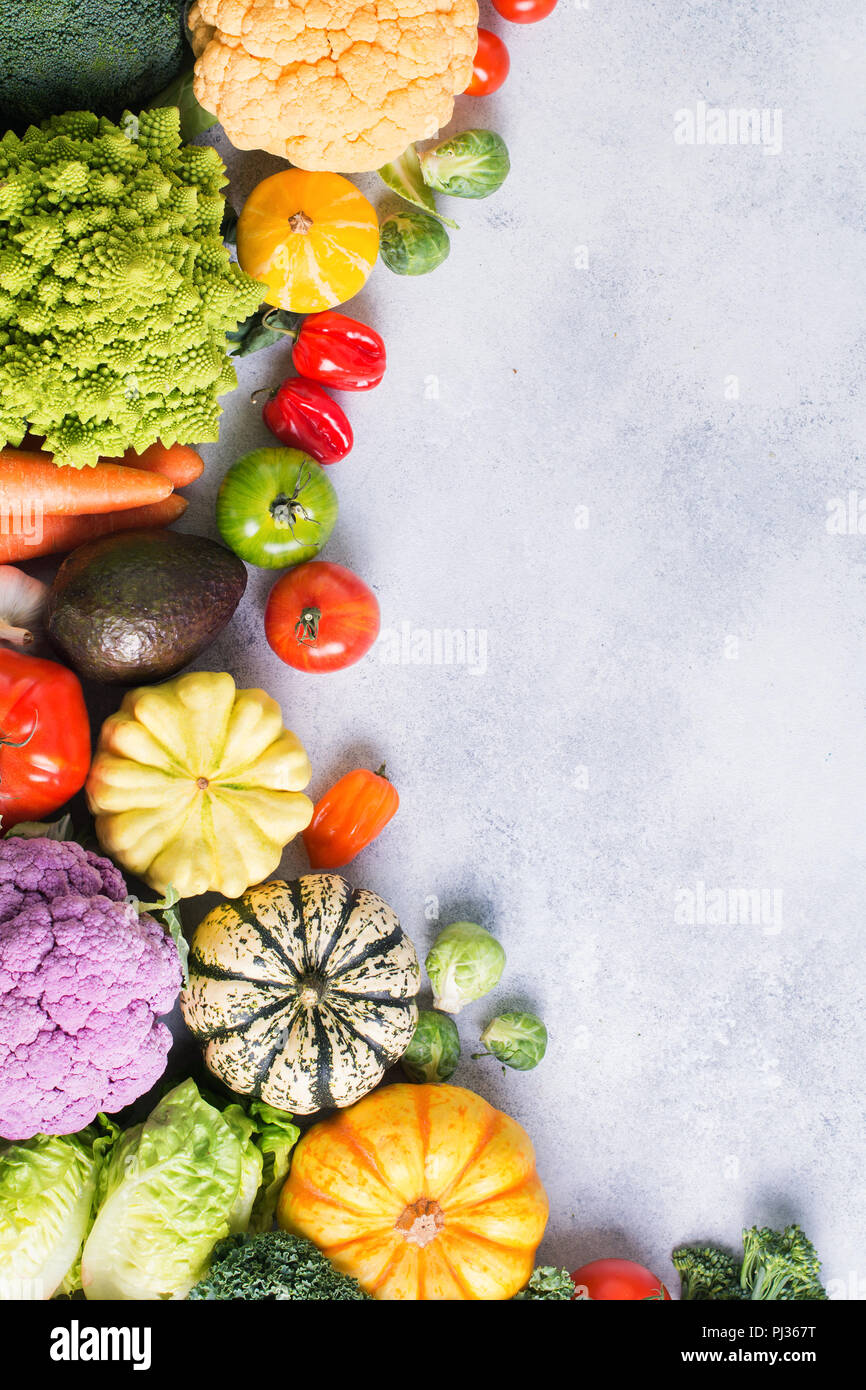 Above view of assorted rainbow colored vegetables on the light grey ...