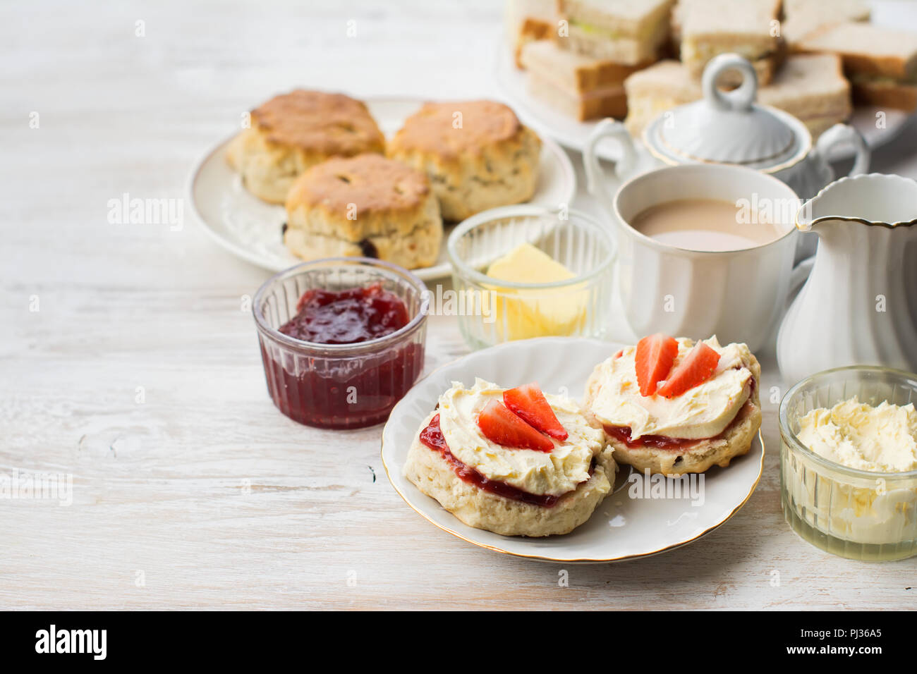 English cream teas, scones with jam and cream, tea with milk, with ...