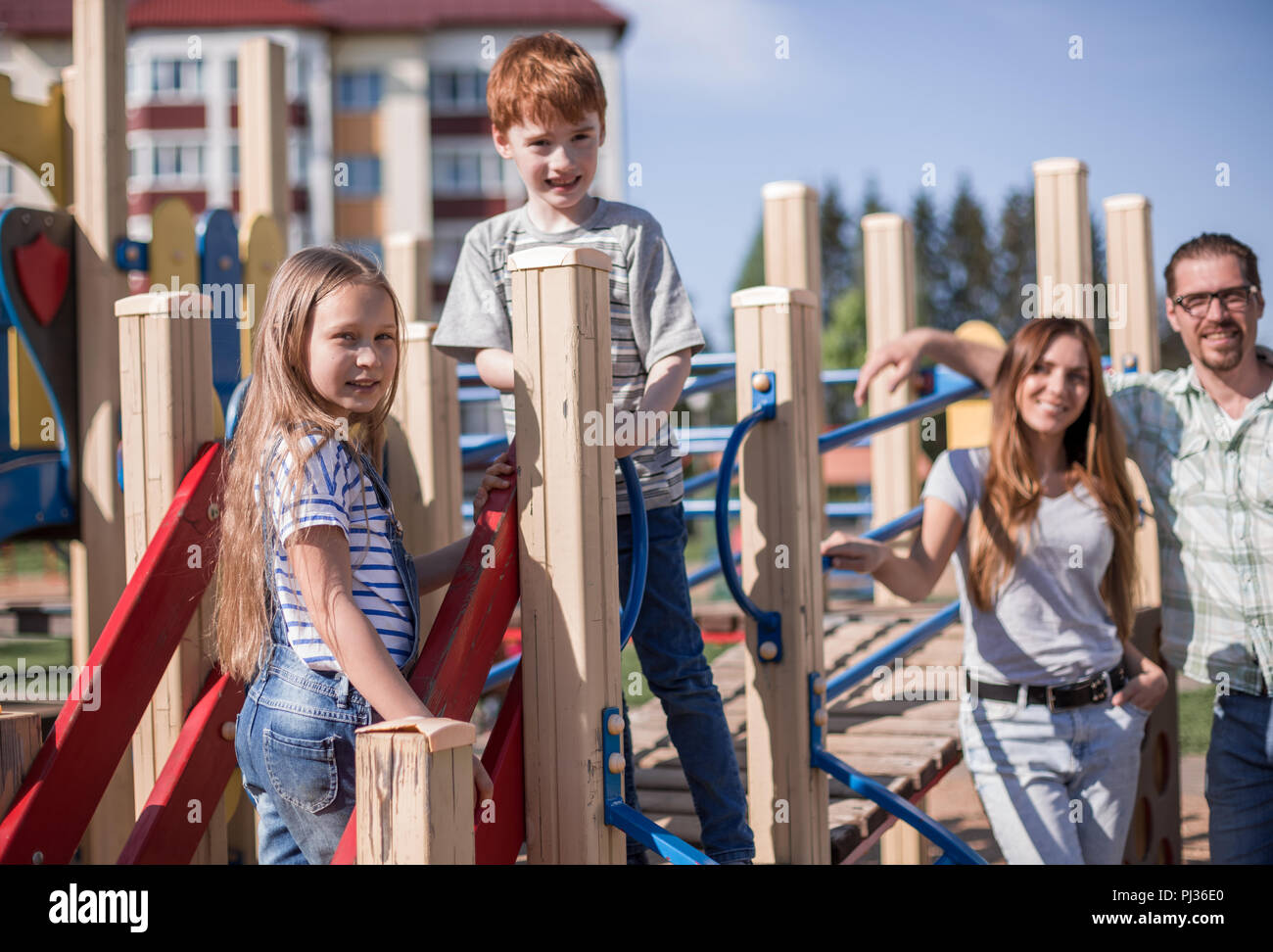 children play with their parents on the Playground Stock Photo - Alamy