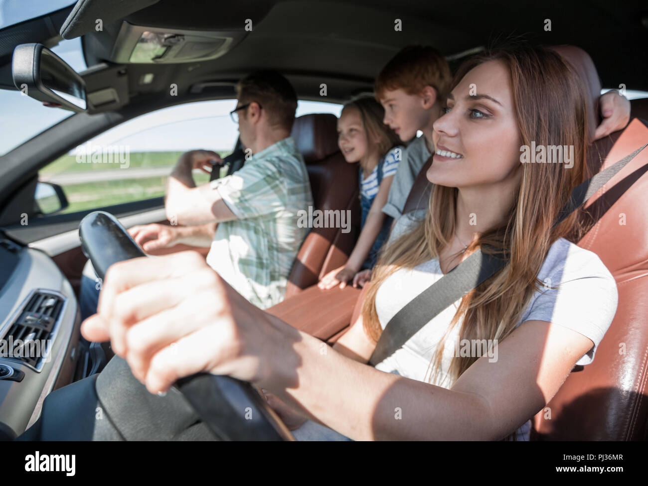 happy mom driving a family car Stock Photo - Alamy