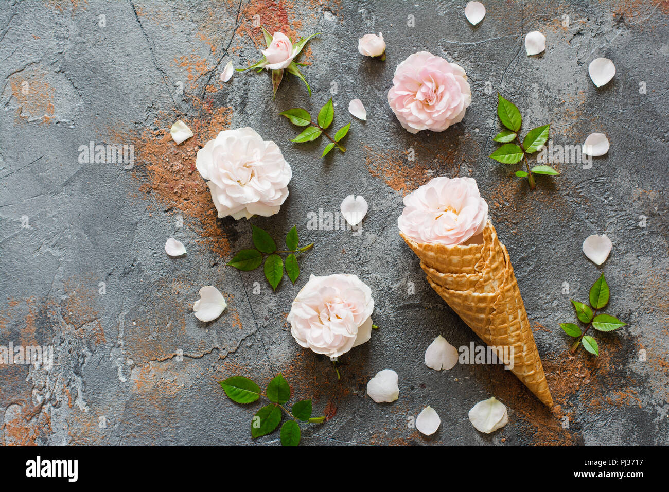 Ice cream cones with roses, overhead composition with flowers, petals ...