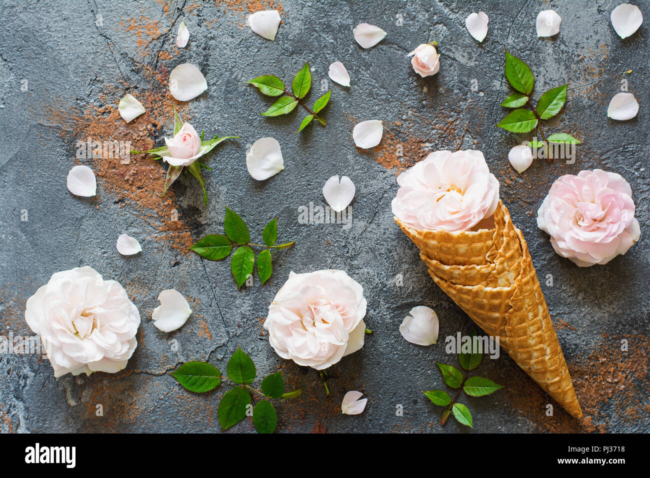 Ice cream cones with roses, overhead composition with flowers, petals ...