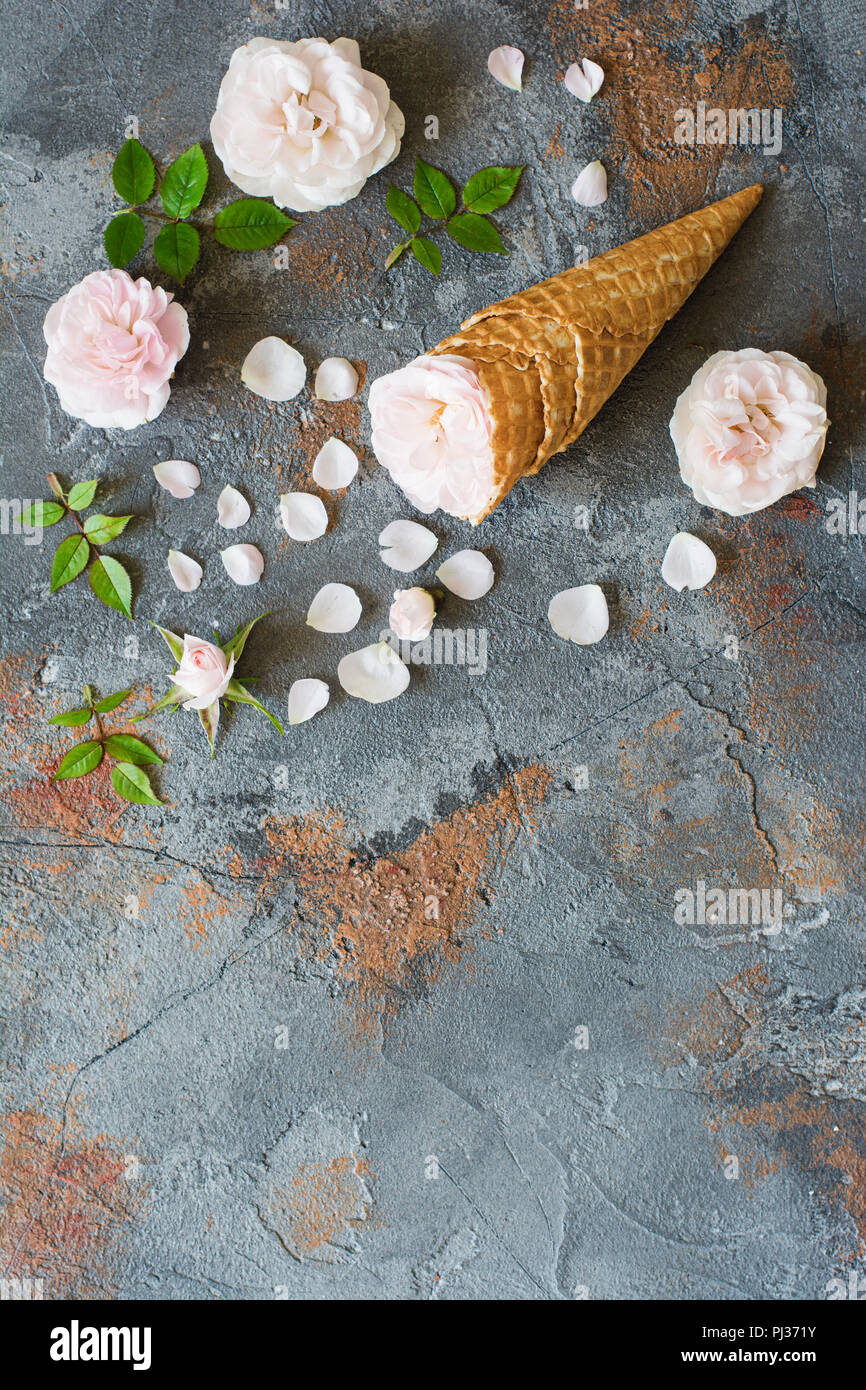 Ice cream cones with roses, overhead composition with flowers, petals ...
