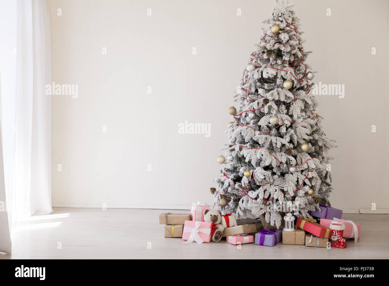Christmas tree with presents new year white scenery Stock Photo - Alamy