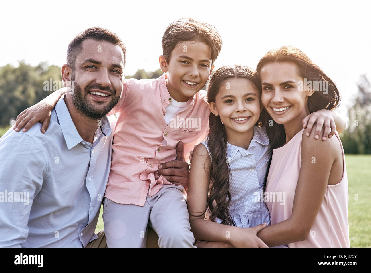 Happy family four standing on hi-res stock photography and images - Alamy