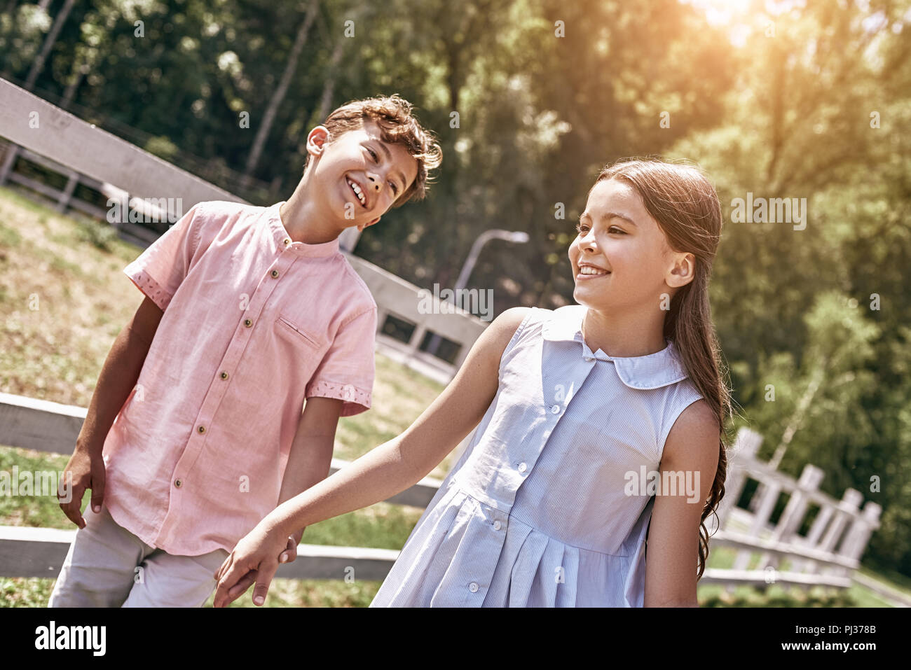 Friendship. Little boy and girl walking together outdoors holdin Stock Photo - Alamy