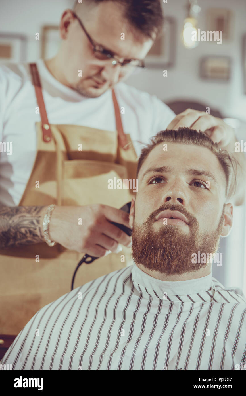 Man during trimming hair in a barbershop Stock Photo - Alamy