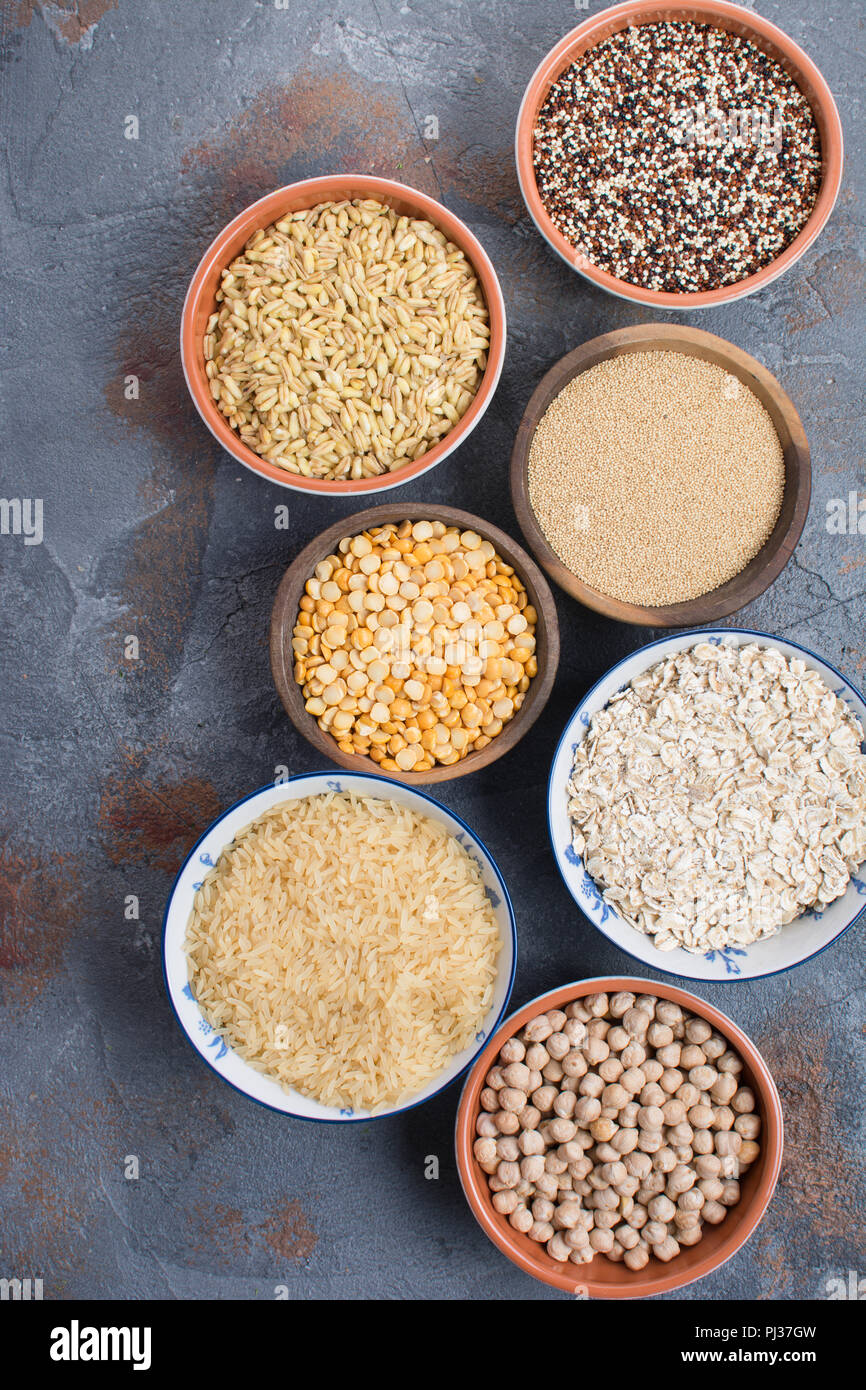 Different grains and cereal on the grey stone background, top view ...