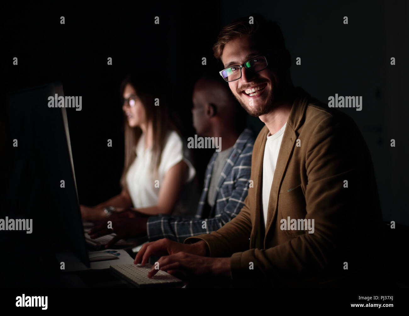 businessman working on the computer in the office at night Stock Photo ...