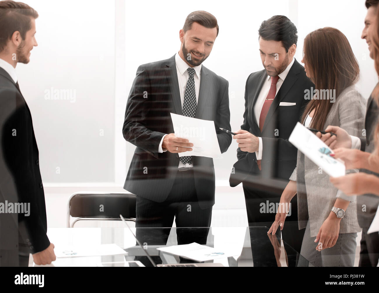 Business team examining documents hi-res stock photography and images ...