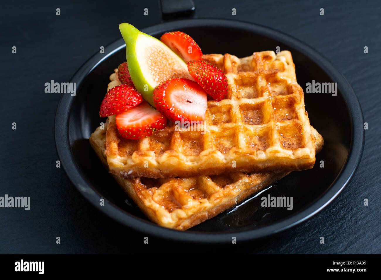 Food concept square Waffles and syrup with strawberry and fig topping ...