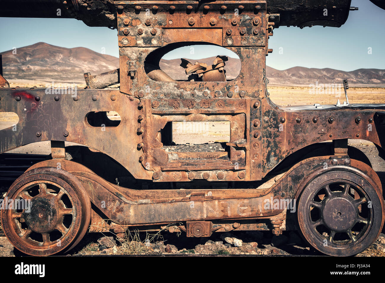 Wheel of an old rusty wagon abandoned in the train cemetery of Uyuni ...