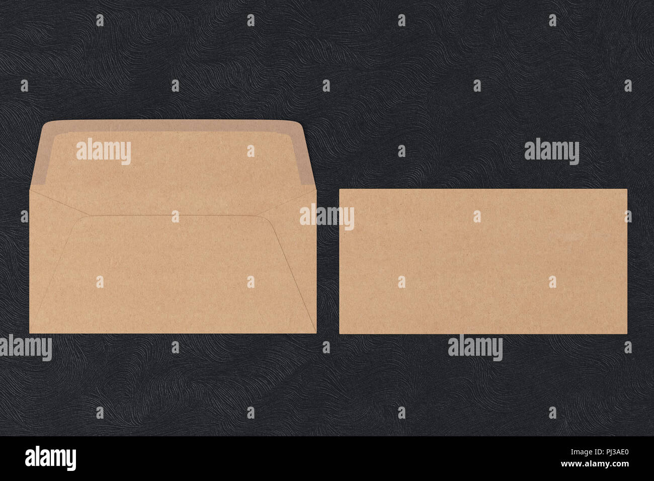 Craft paper blank closed envelope and open envelope on black background ...