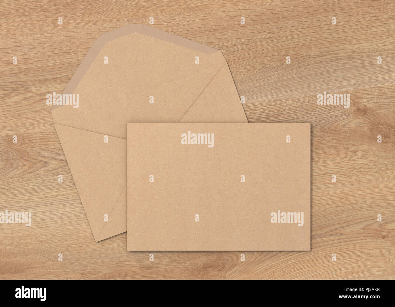 Craft paper blank closed envelope on opened envelope on wooden ...