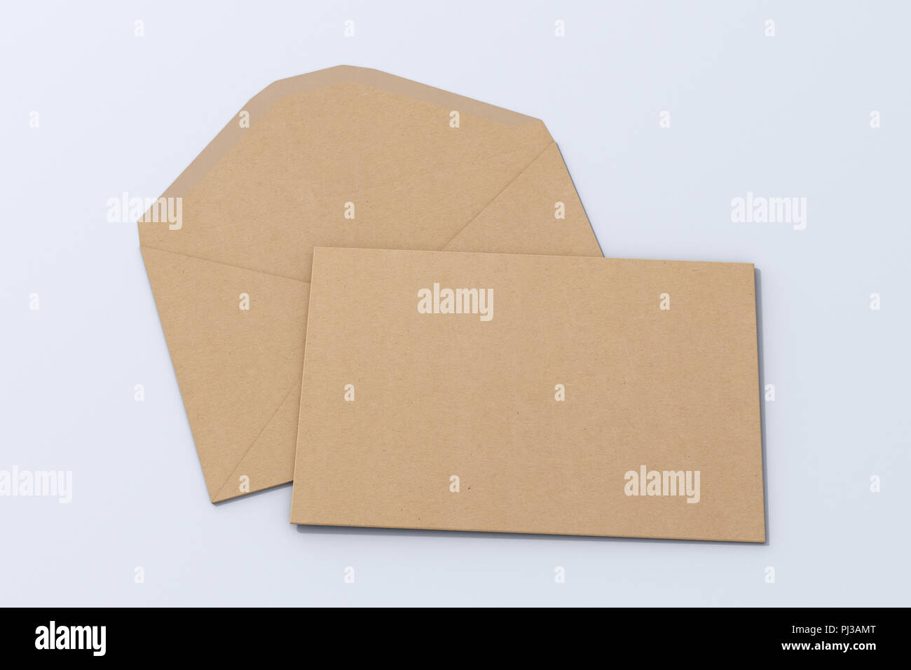 Craft paper blank closed envelope on opened envelope on white ...
