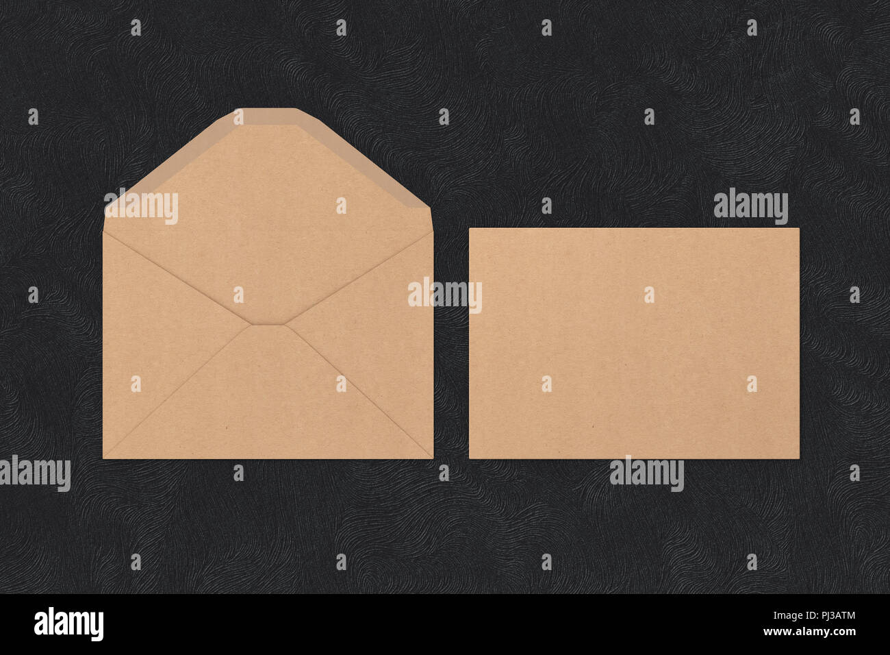 Craft paper blank closed envelope and open envelope on black background ...