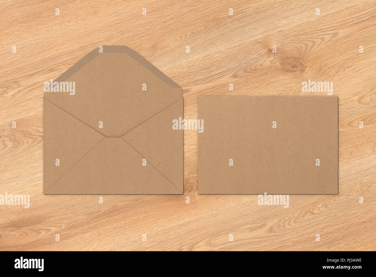 Craft paper blank closed envelope and open envelope on wooden ...