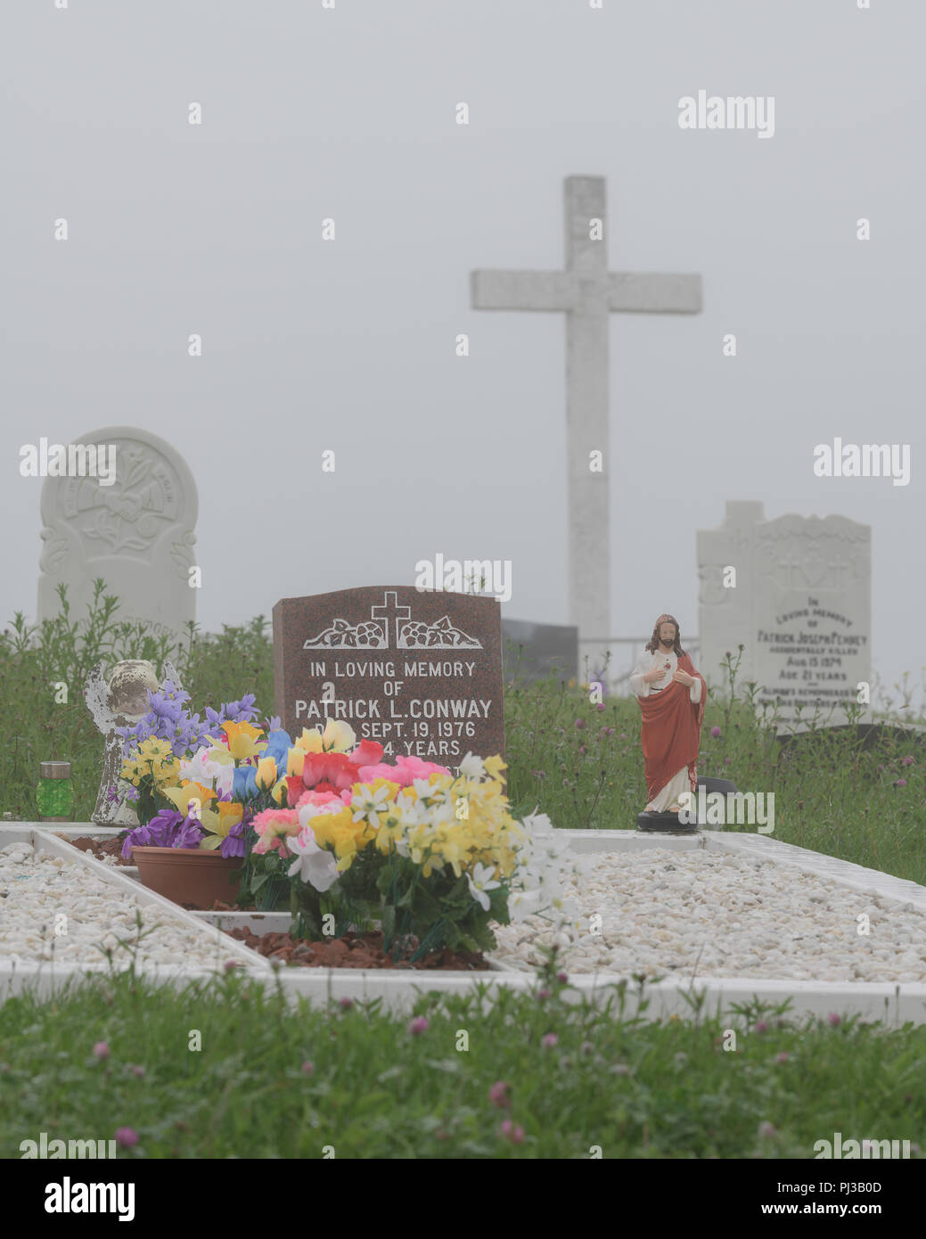 Tombstones in the fog at the cemetery of the Sacred Heart Catholic ...