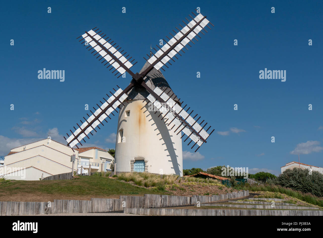 a beautiful white windmill,The background of blue sky Stock Photo - Alamy