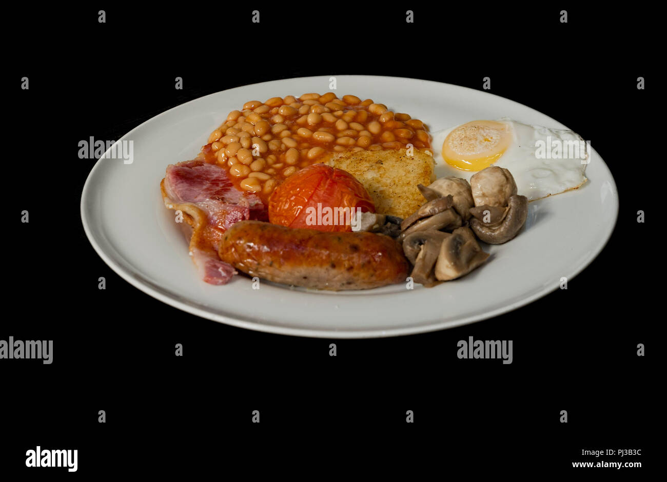 Traditional English Breakfast on white plate on black background Stock ...