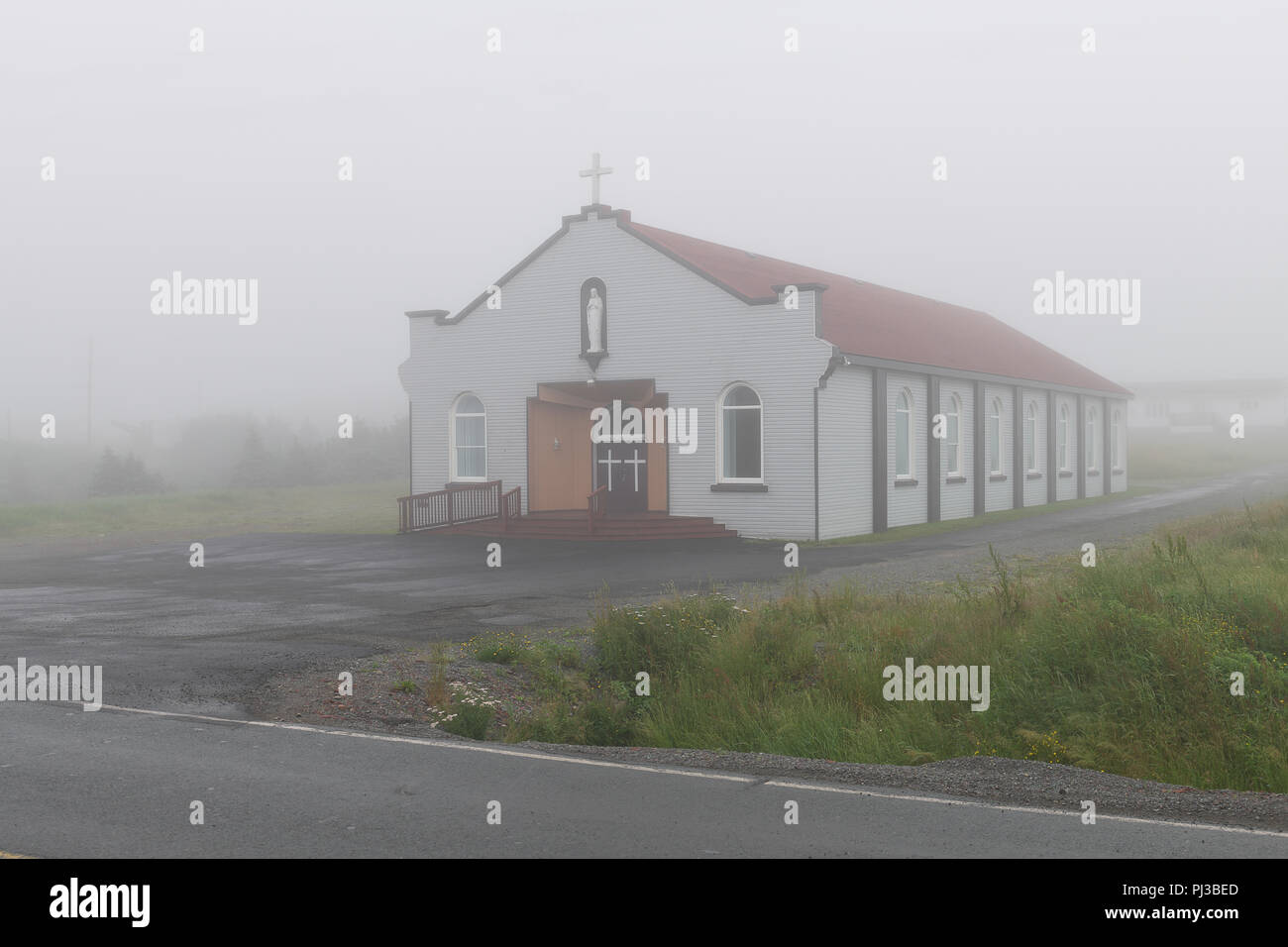 Sacred Heart Catholic Church in the fog on Main Street in Saint Bride's ...
