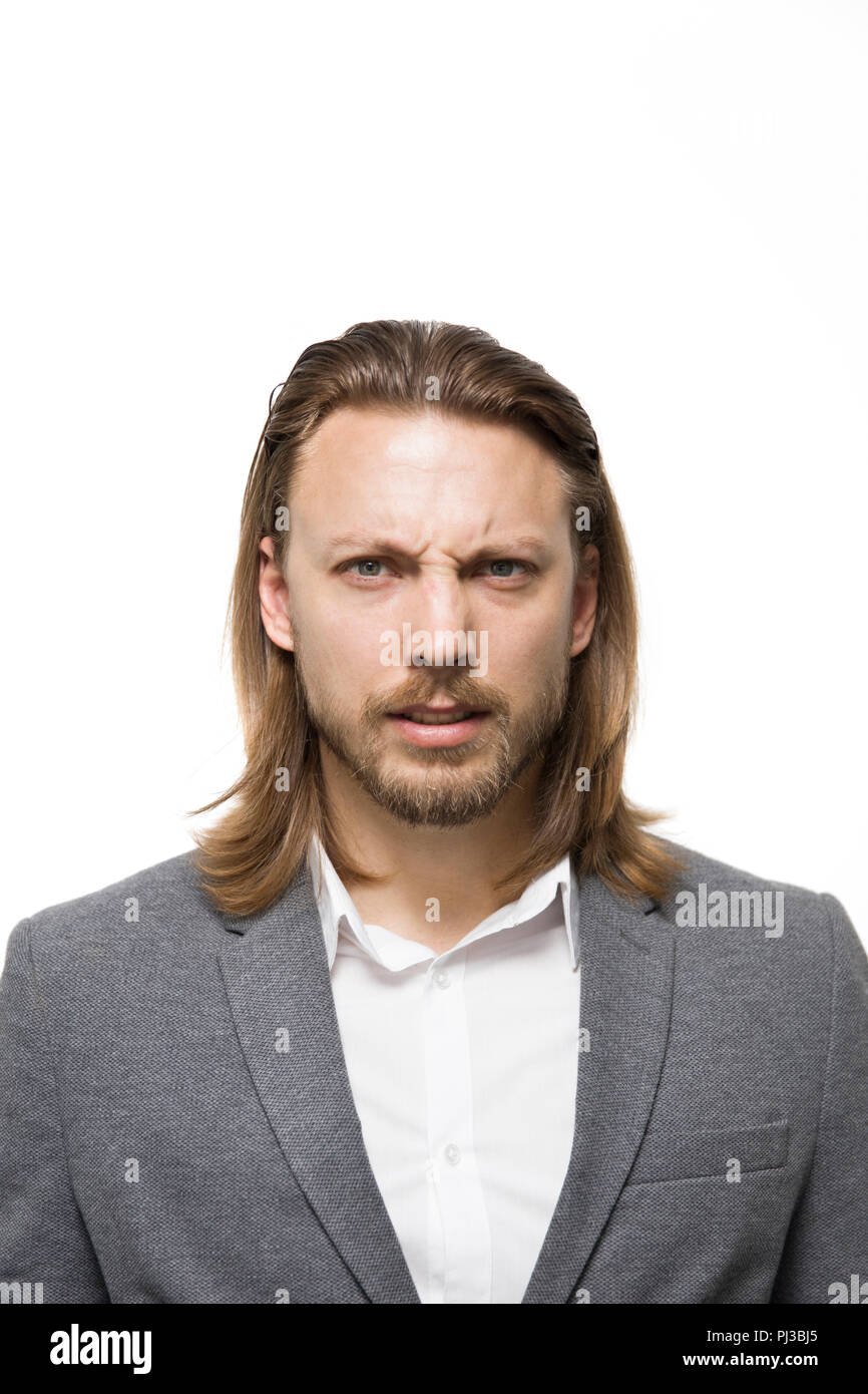 Angry young business man standing in the office Stock Photo - Alamy